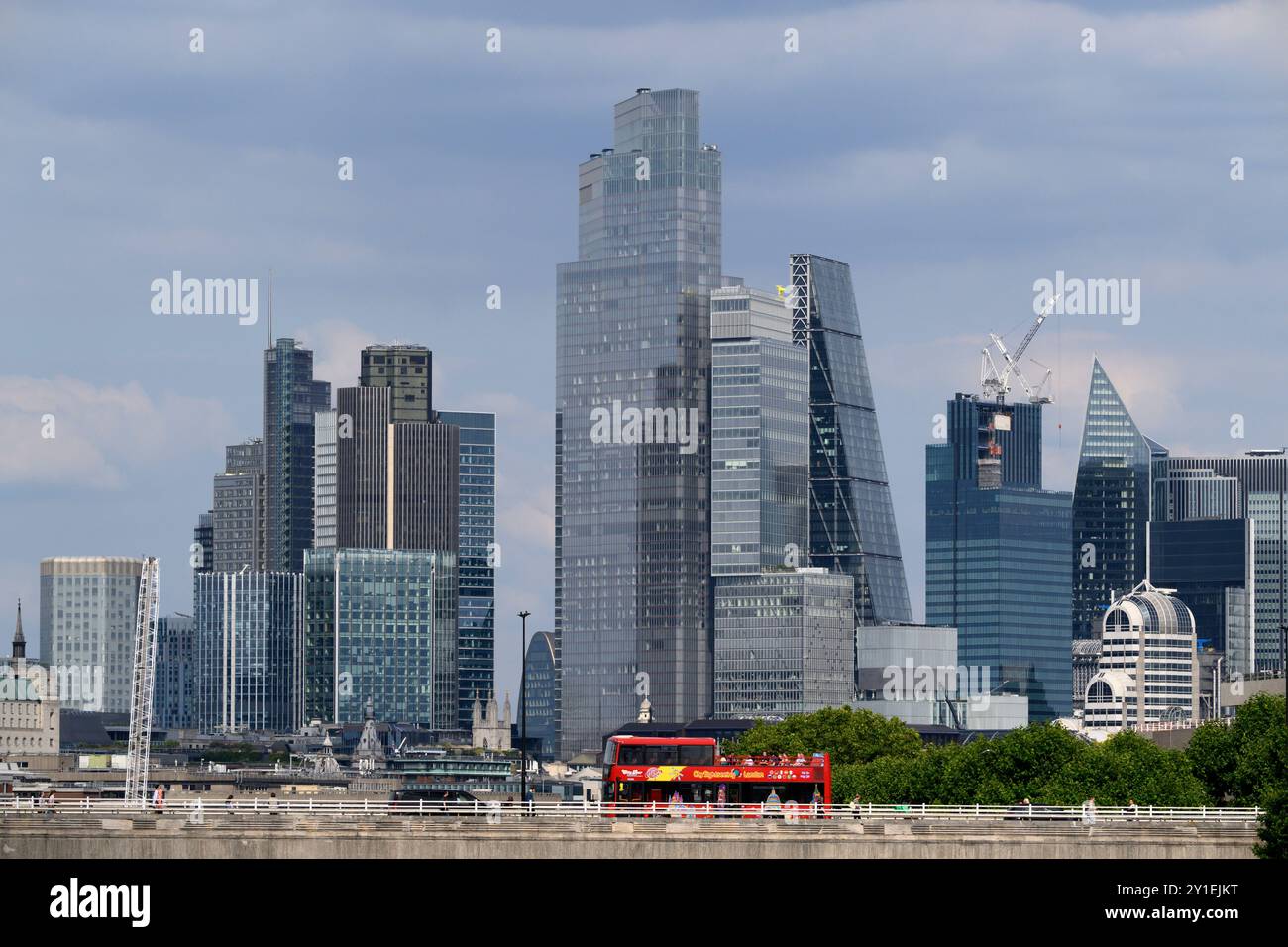 A double-decker sightseeing bus crosses Waterloo Bridge over the River ...