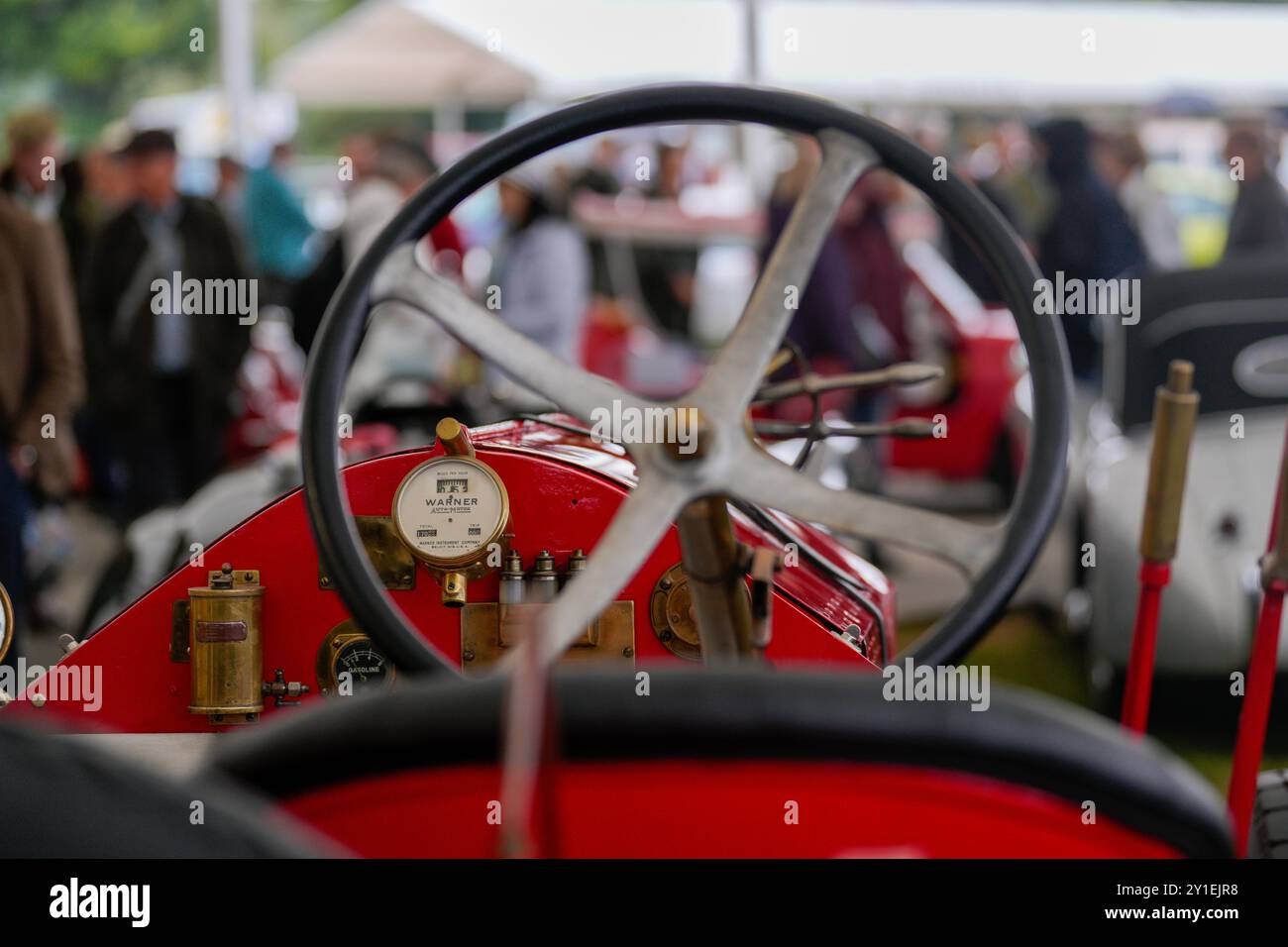 Looking through the open cockpit and steering wheel to the dashboard of ...