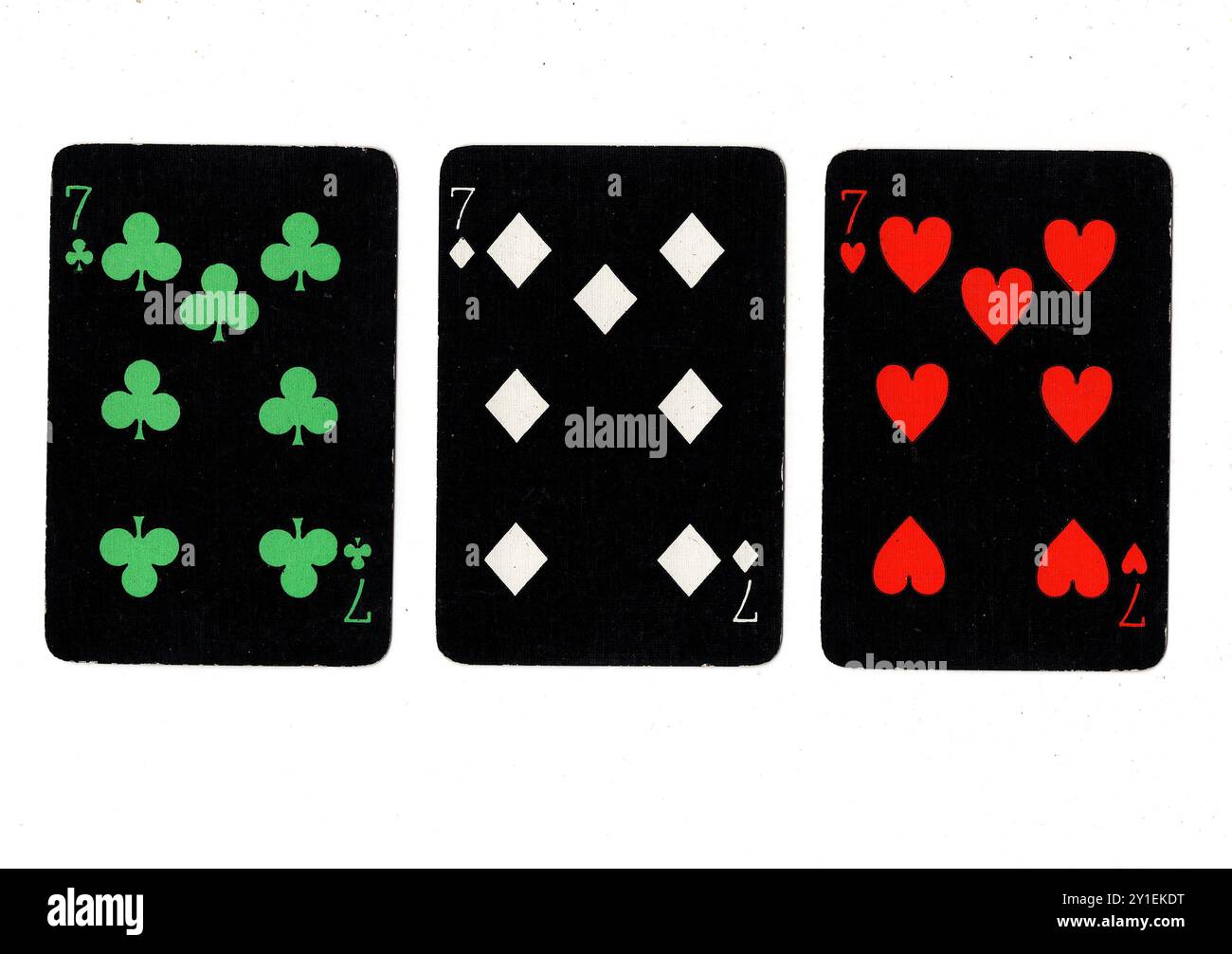 Vintage black playing cards showing three sevens on a white background ...