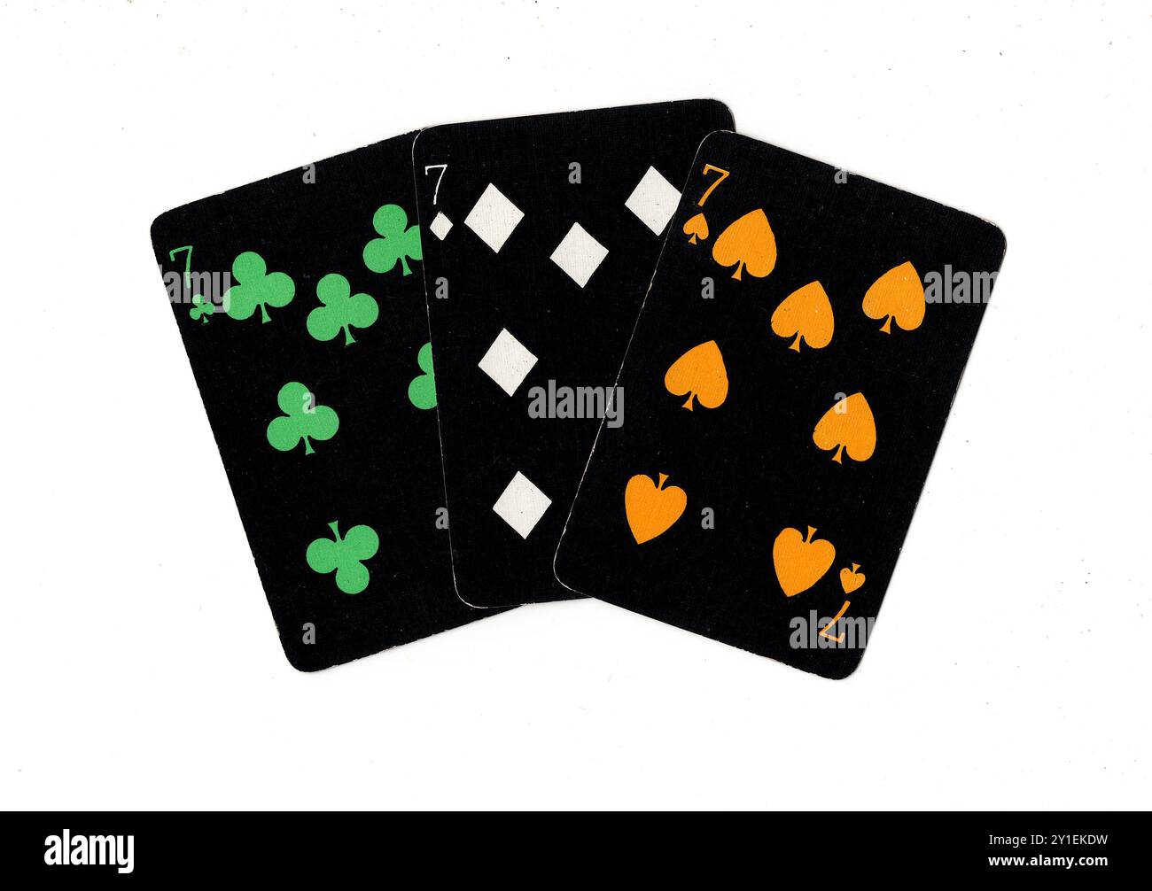 Vintage black playing cards showing three sevens on a white background ...