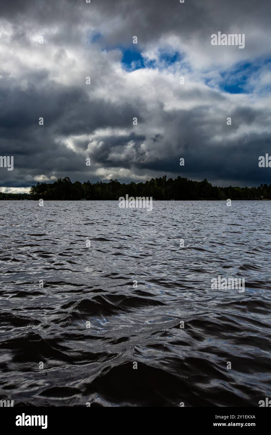 Cloudy, dark morning on a Wisconsin lake in August, vertical Stock ...