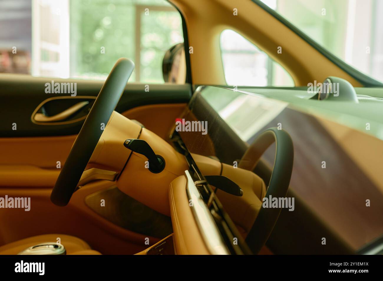 Side view of steering wheel and dashboard in modern looking beige cabin ...