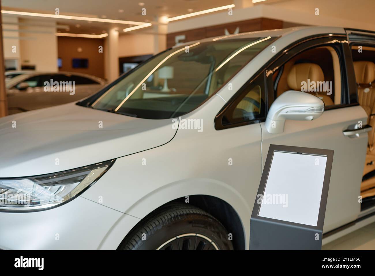 Silver display model of new SUV car demonstrated in vehicle showroom ...