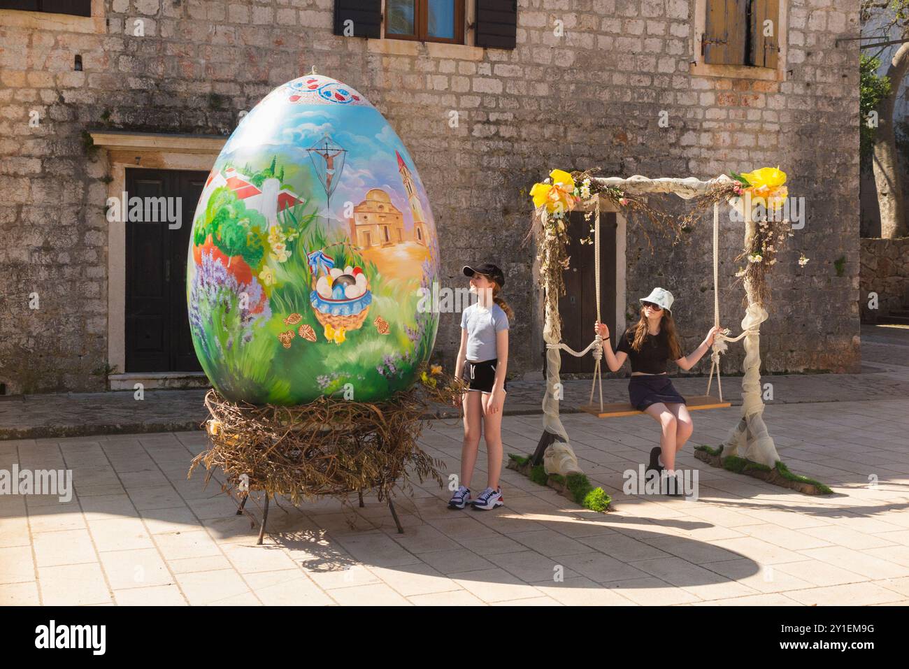 Children & swing and giant Easter egg, celebration of Christ's ...