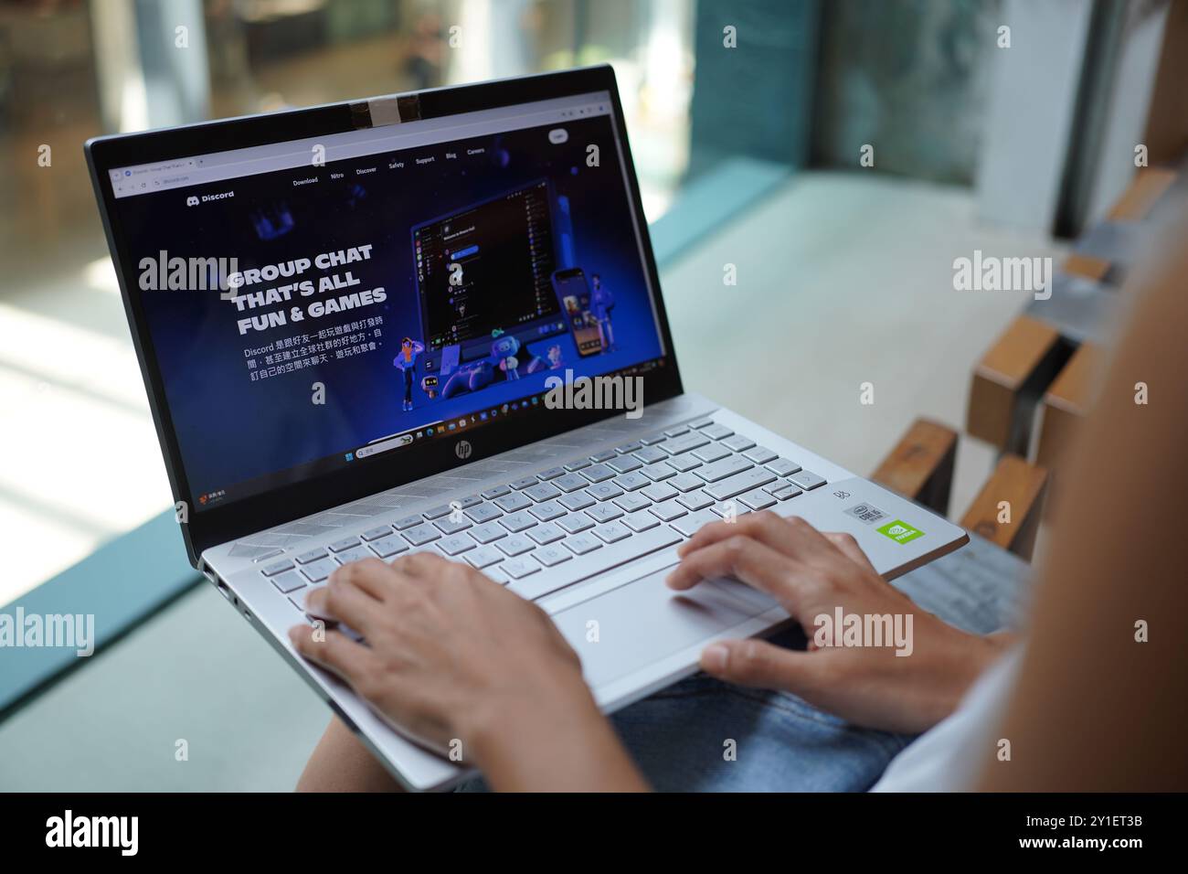 In this photo illustration, a woman browses Discord website on her ...