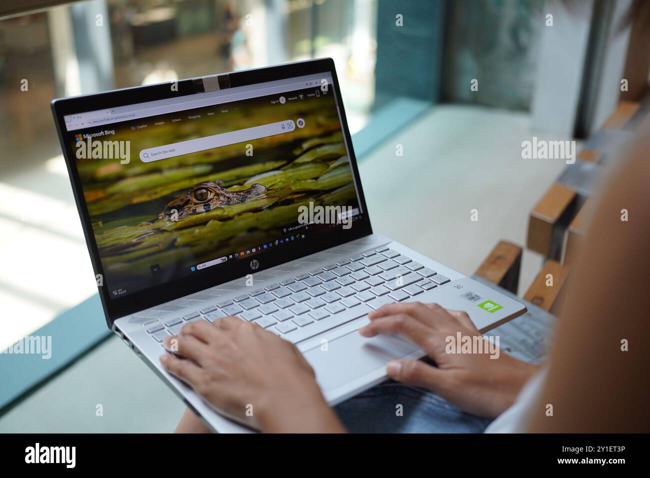 In this photo illustration, a woman browses Microsoft Bing website on ...