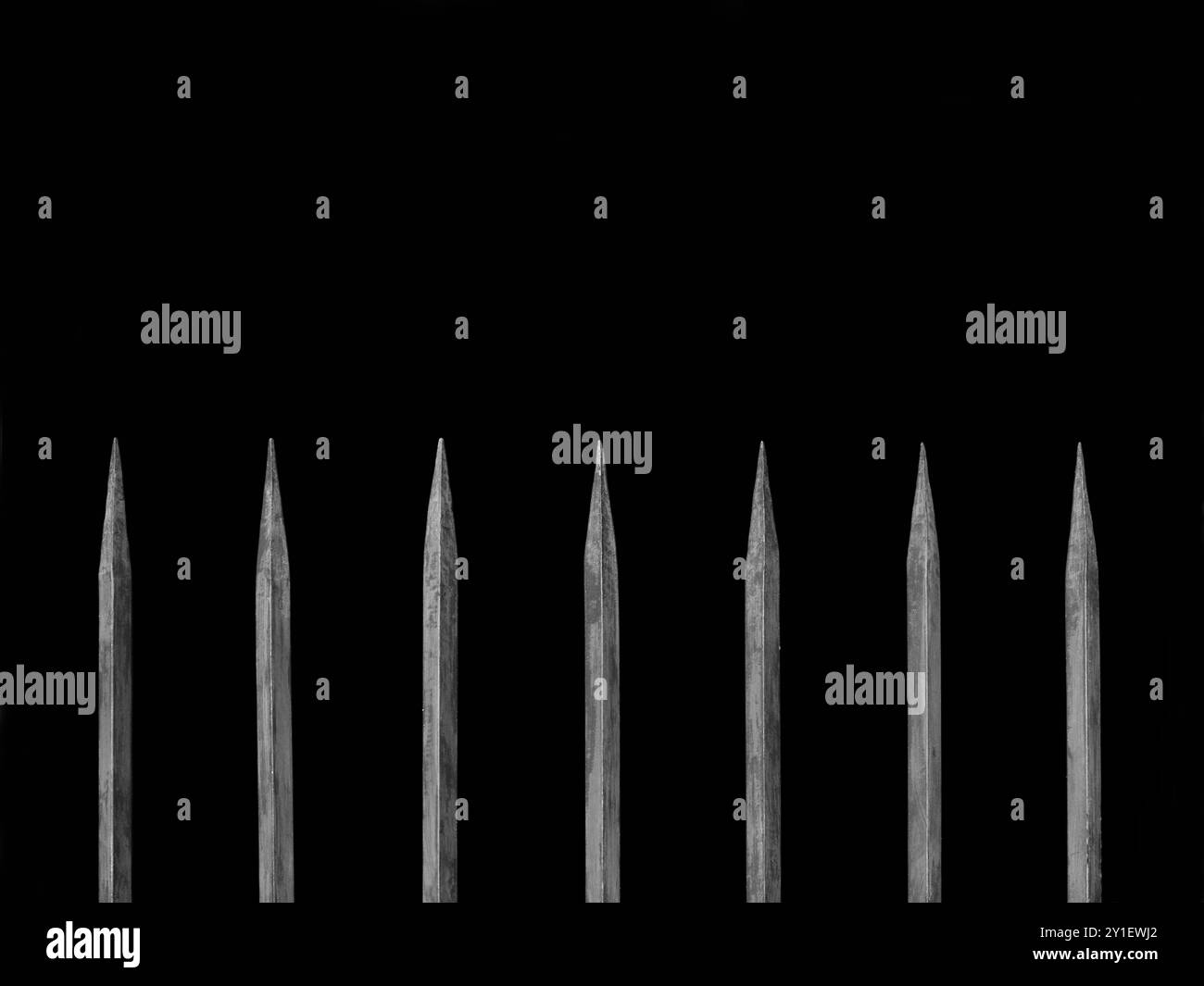 Steel fence barrier with pointed bars as metal teeth (Black and white ...