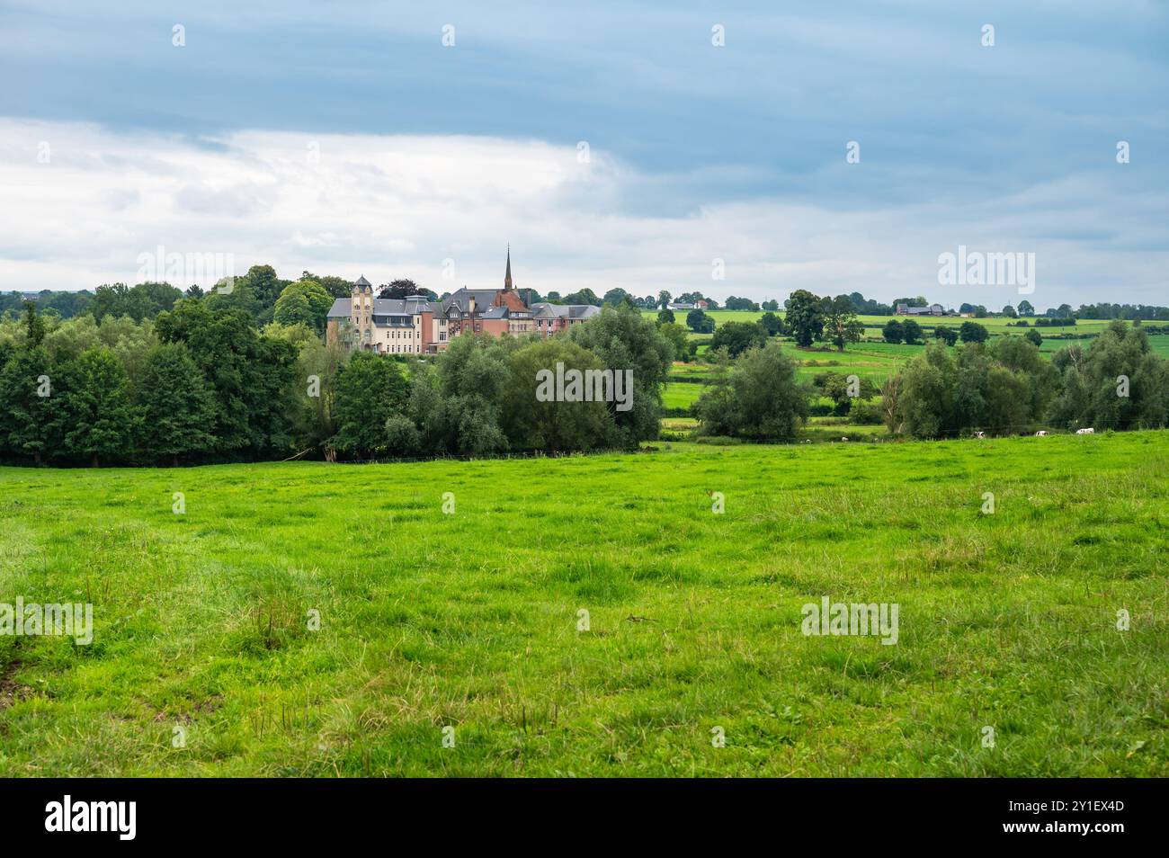 Green hills and meadows at the Belgian countryside with the Chateau ...
