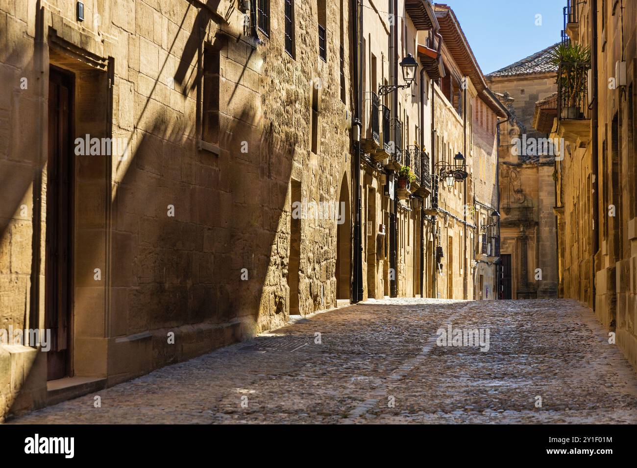 Deserted medieval street San Juan with buildings built of ashlar stone ...