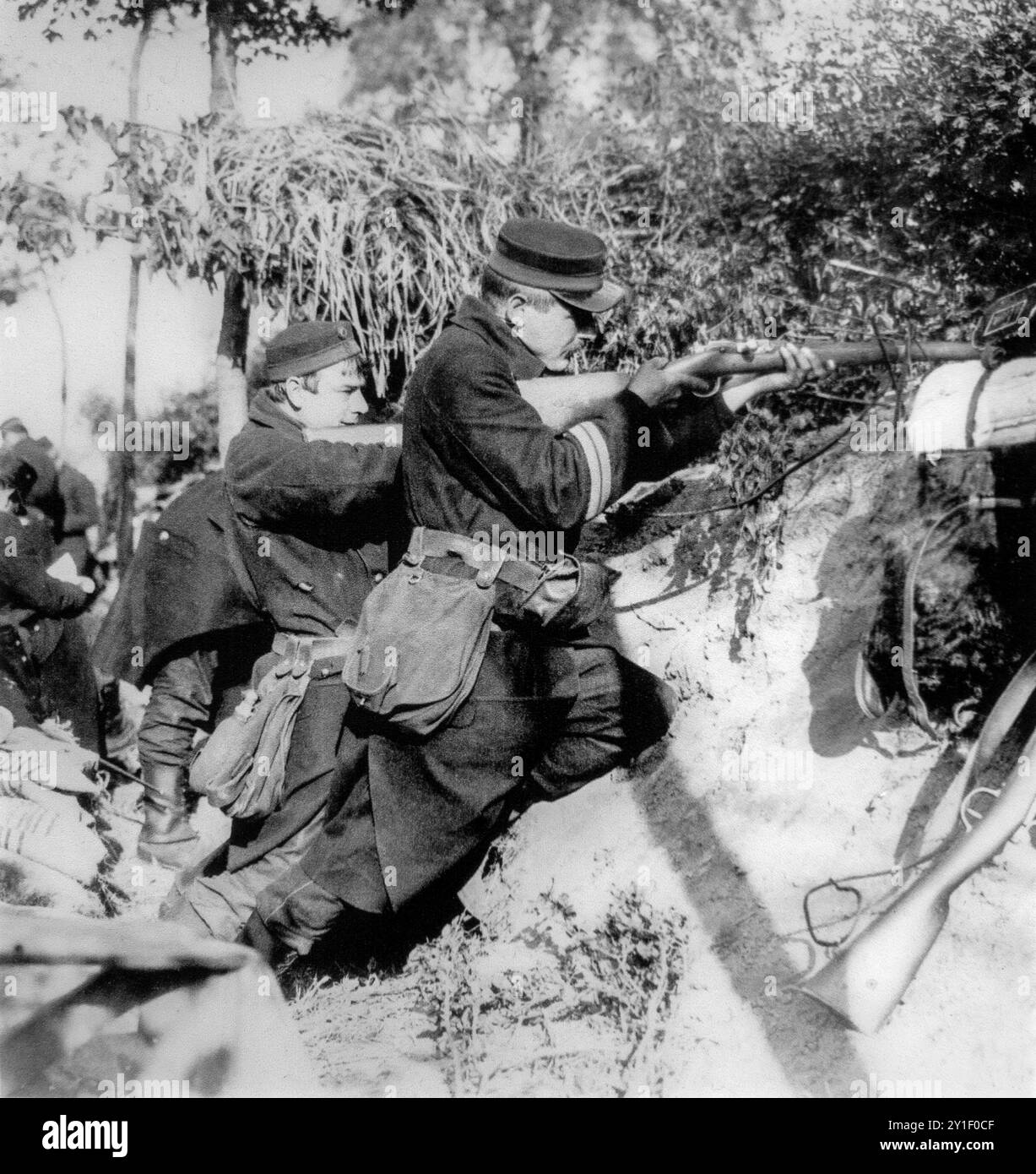 WWI Belgian infantrymen in trench shooting with Mauser Model 1889 bolt ...