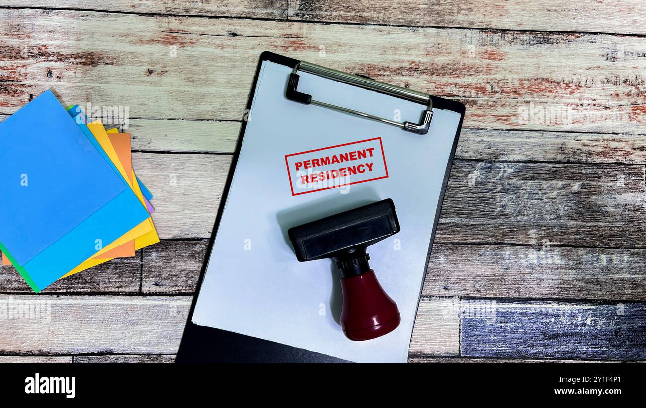 Red Handle Rubber Stamper and Permanent Residency text on a paperwork ...