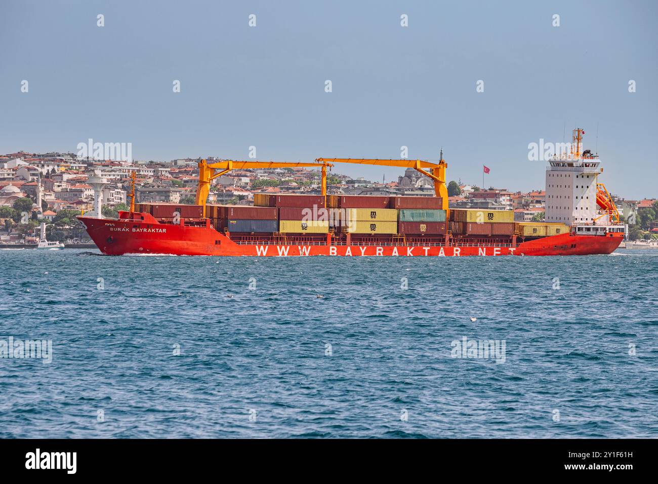 09 July 2024, Istanbul, Turkey: A large cargo vessel at a bustling port ...