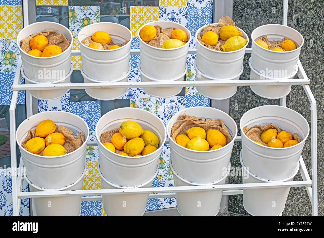 fresh lemons in decorative buckets on the counter in the supermarket ...