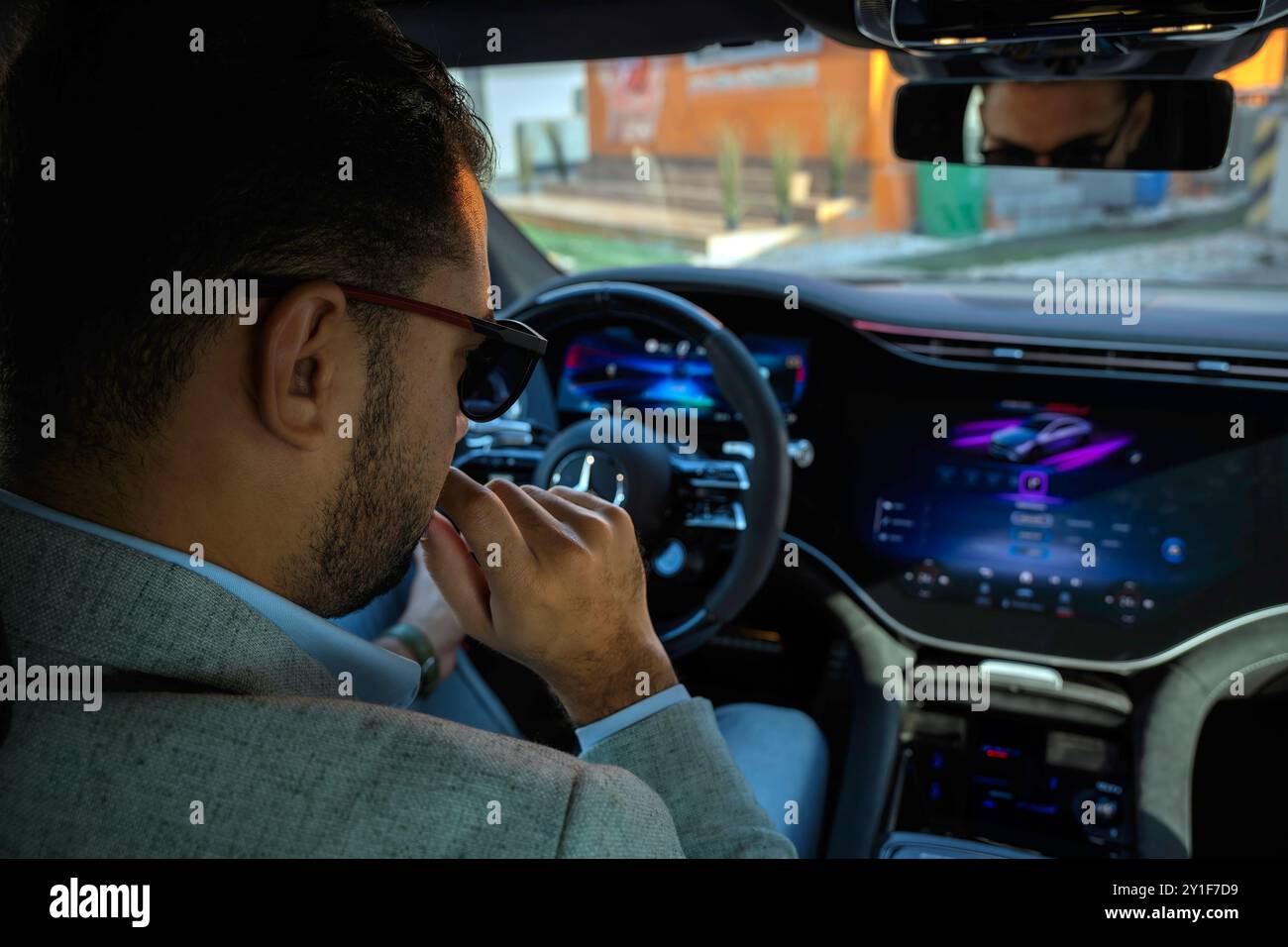 Close up view of steering wheel of Mercedes. Man sitting in the car ...