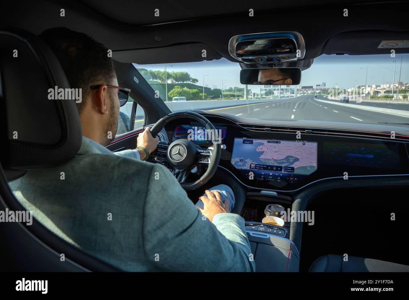 Close up view of steering wheel of Mercedes. Man sitting in the car ...