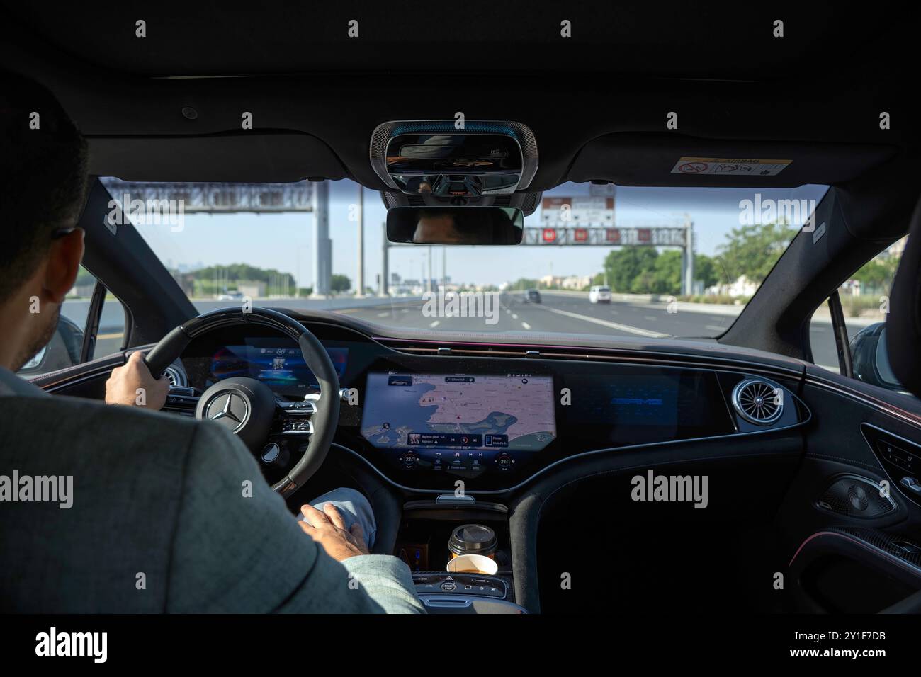 Close up view of steering wheel of Mercedes. Man sitting in the car ...
