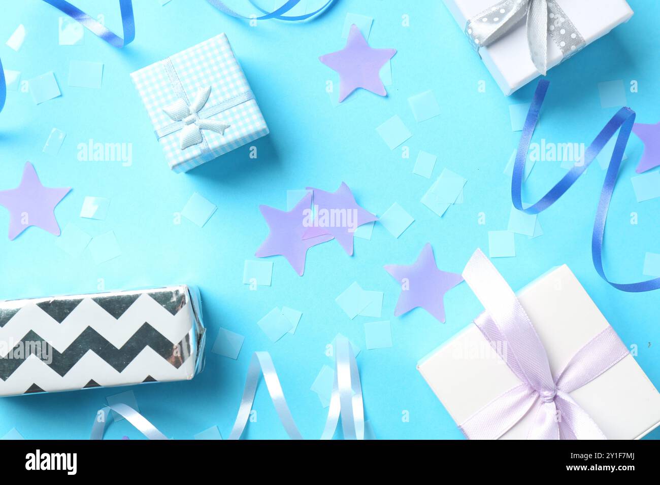 Confetti, party streamers and gift boxes on light blue background, flat ...