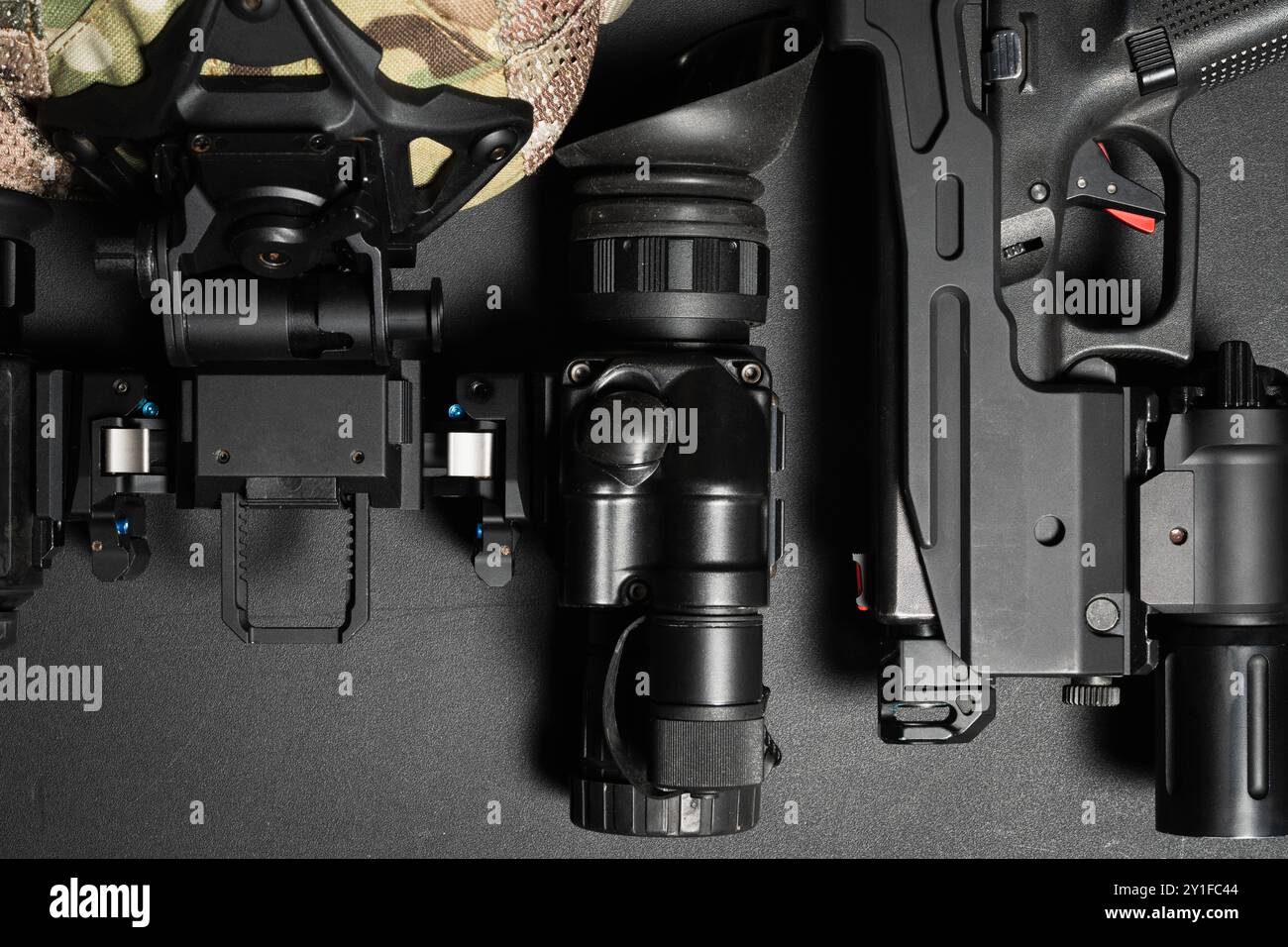 Tactical gear, head-mounted night vision goggles and a pistol with ...