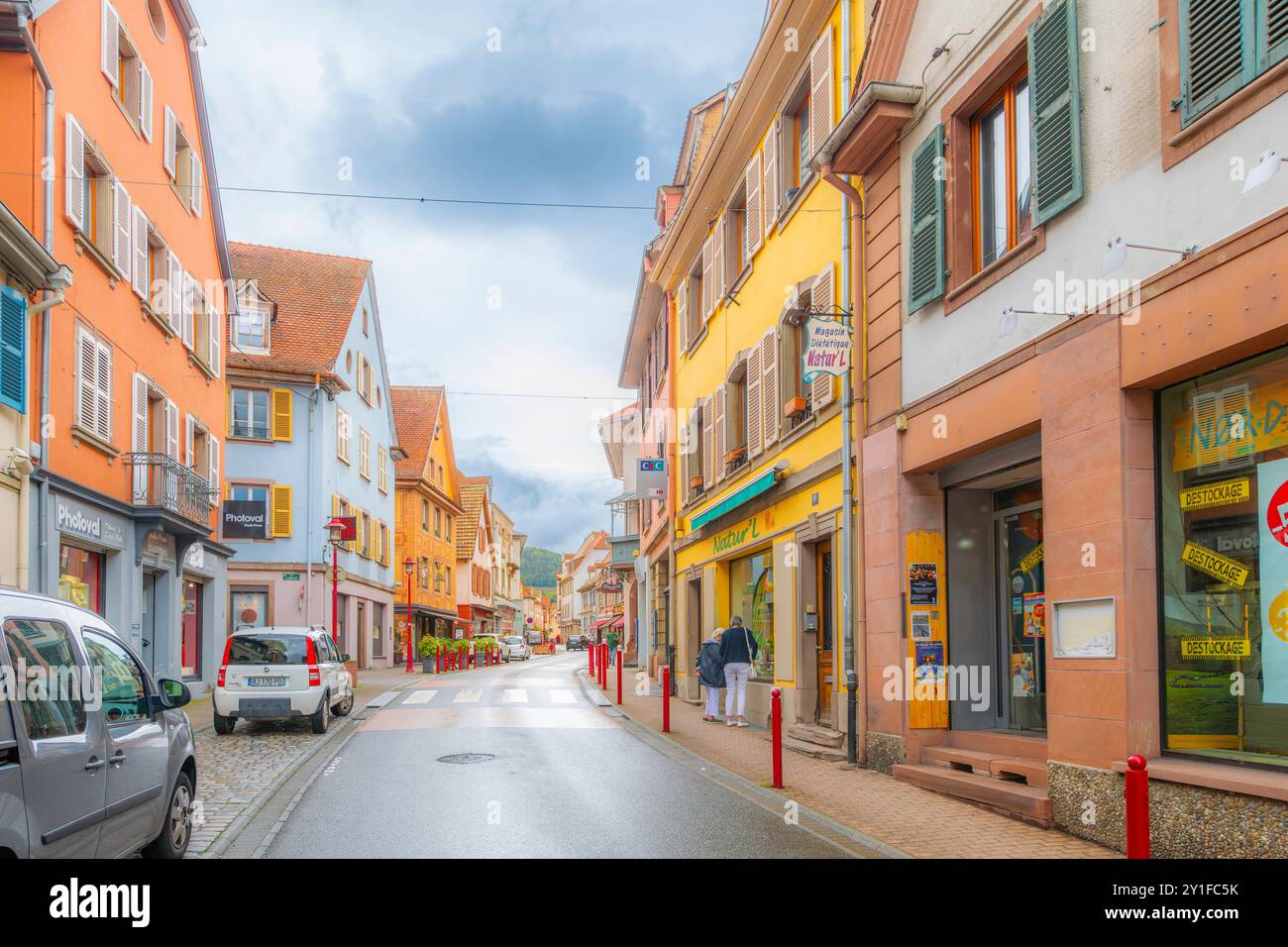 The picturesque colorful Grand Rue street with sidewalk cafes and shops ...