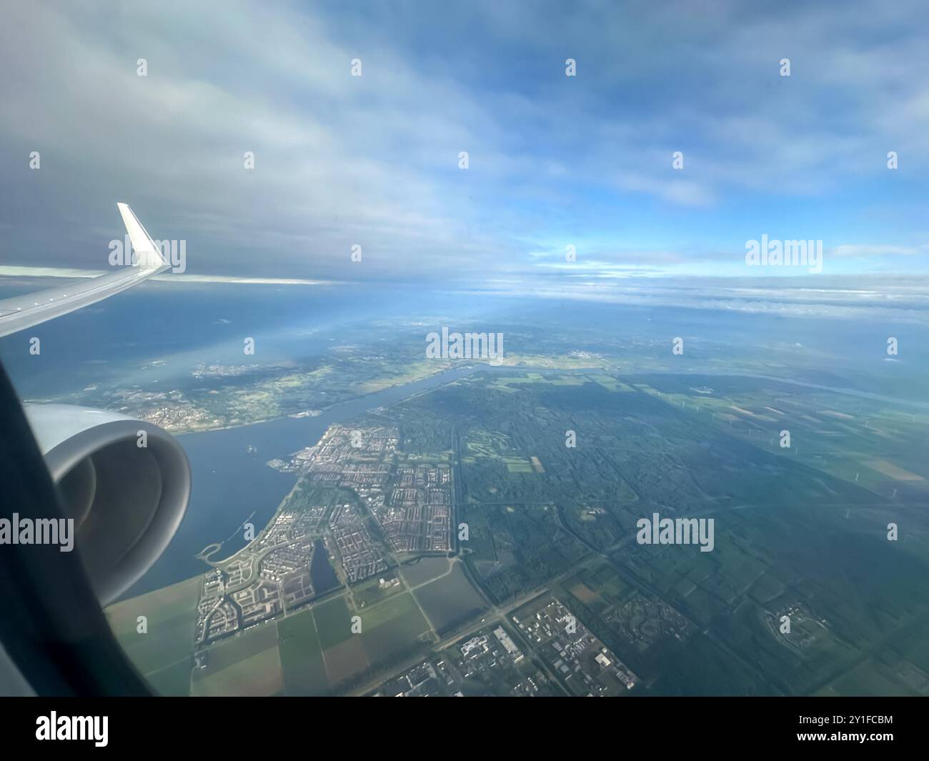 Picturesque view of city through plane window during flight Stock Photo ...