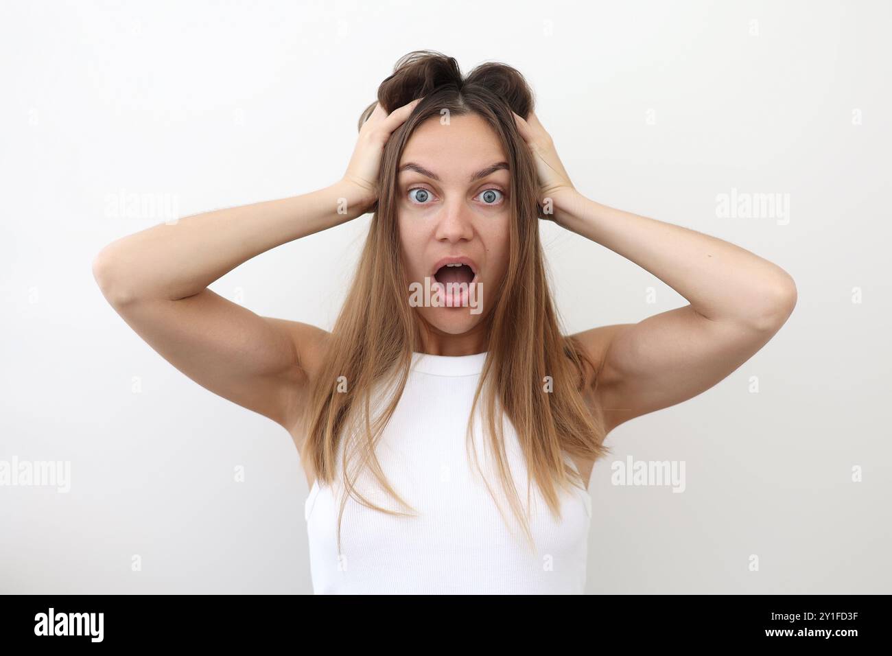 Portrait of shocked anxious caucasian woman in panic, holding hands on ...