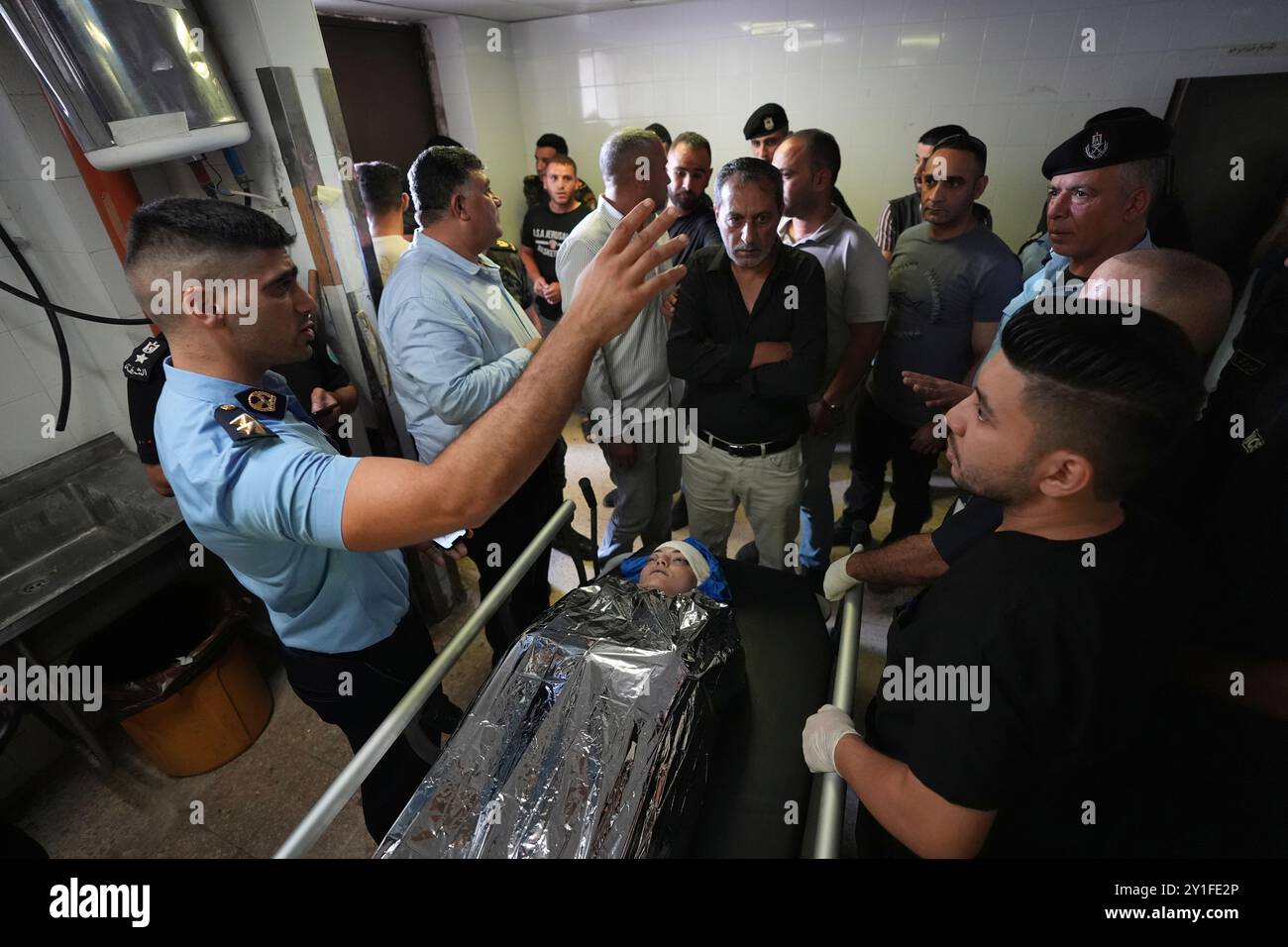 Palestinians gather around the body of Aysenur Ezgi Eygi, 26, who was ...