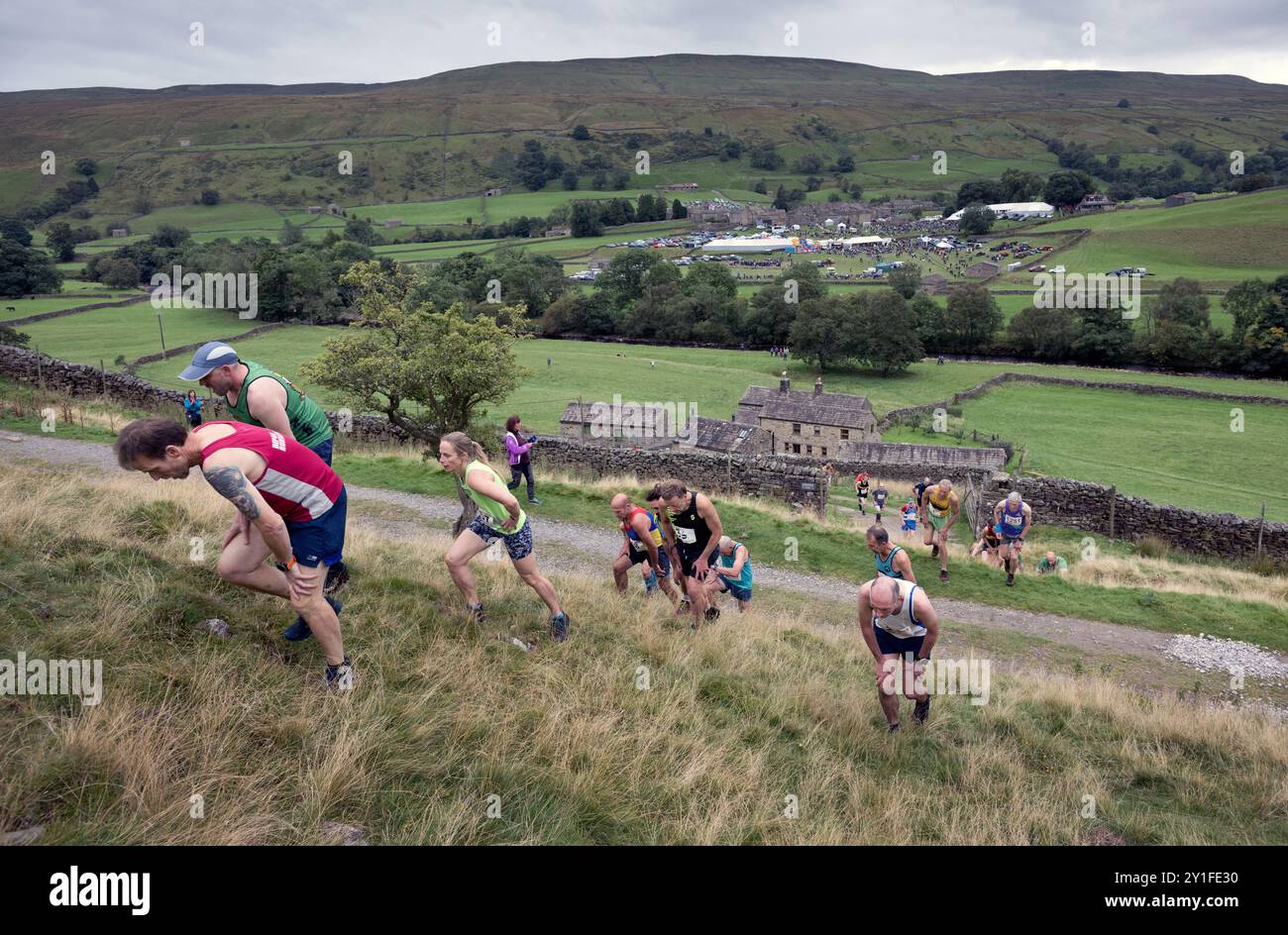 Fell runners climb the hill near the start of the fell race at the ...