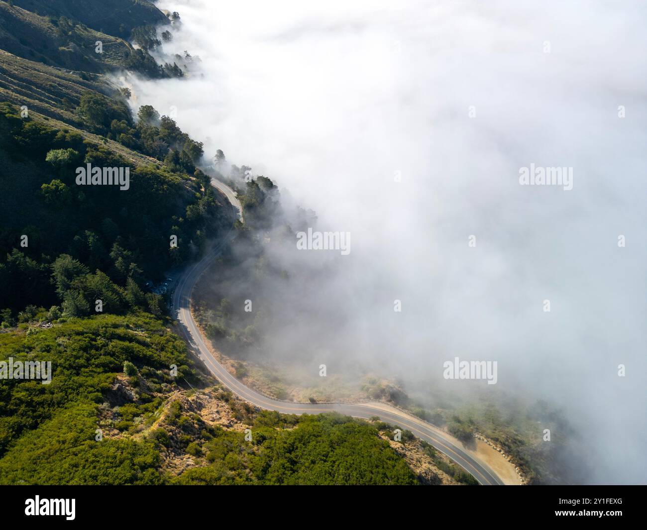 Thick fog hugs the Santa Lucia mountains along highway 1 along the Big ...