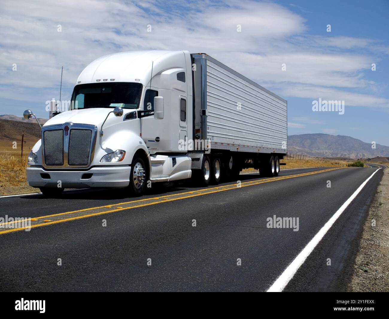 Generic plain white big rig truck heading towards camera at a dramatic ...