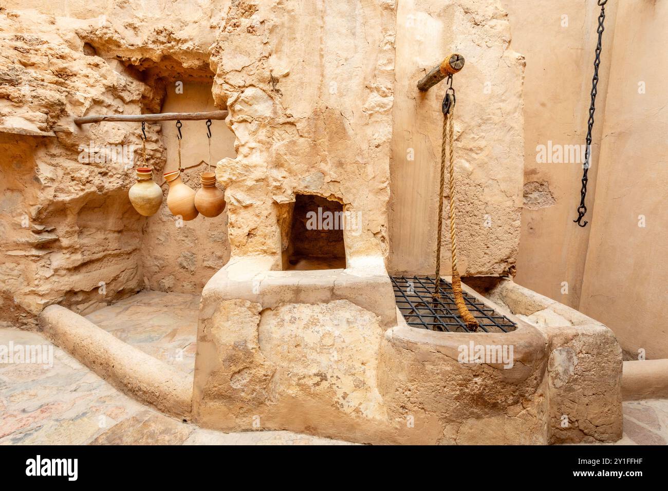 Water well in arabic citadel fortress inner yard and walls with hanging ...