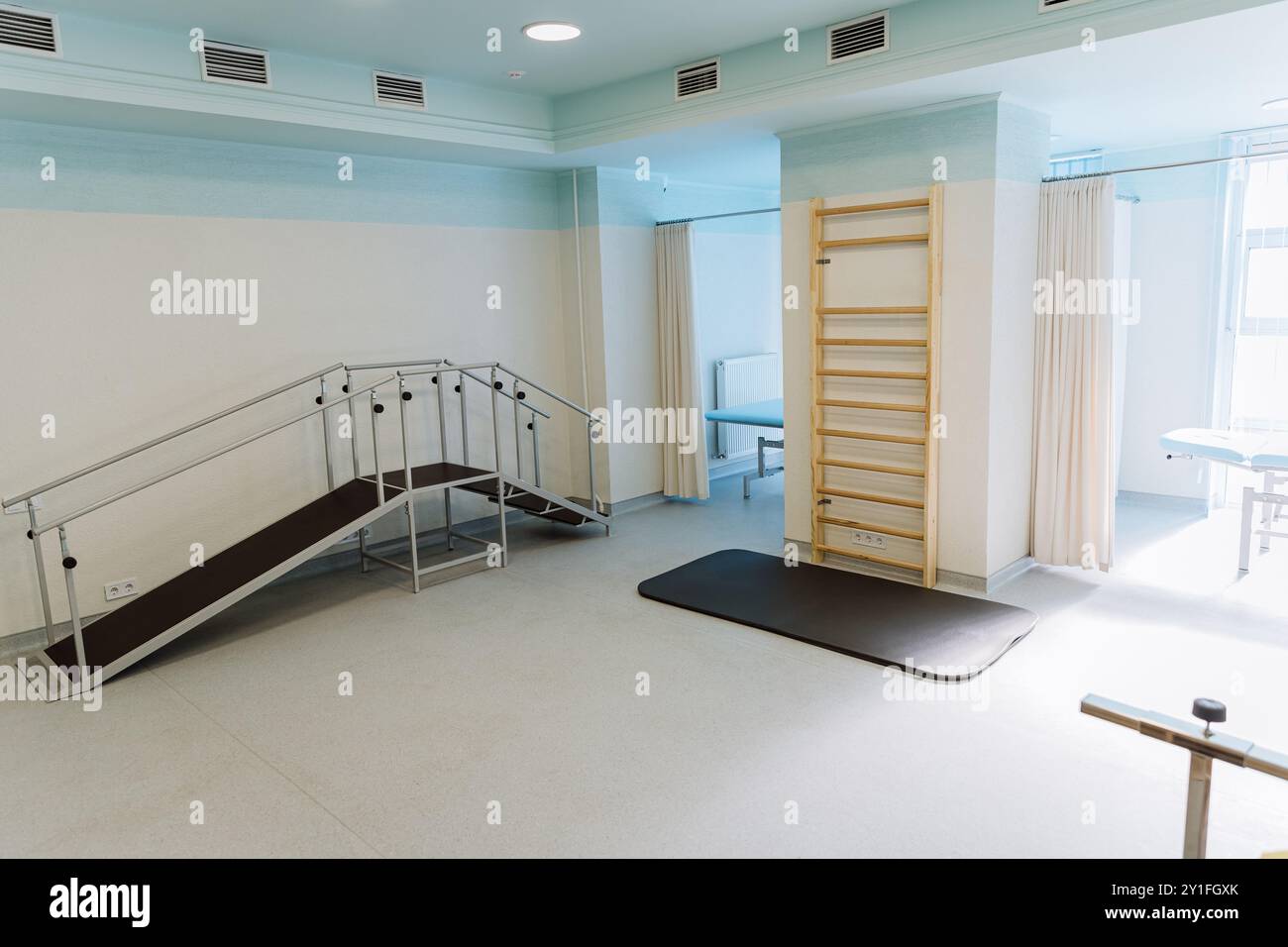 Rehabilitation room with parallel bars and equipment for physical ...