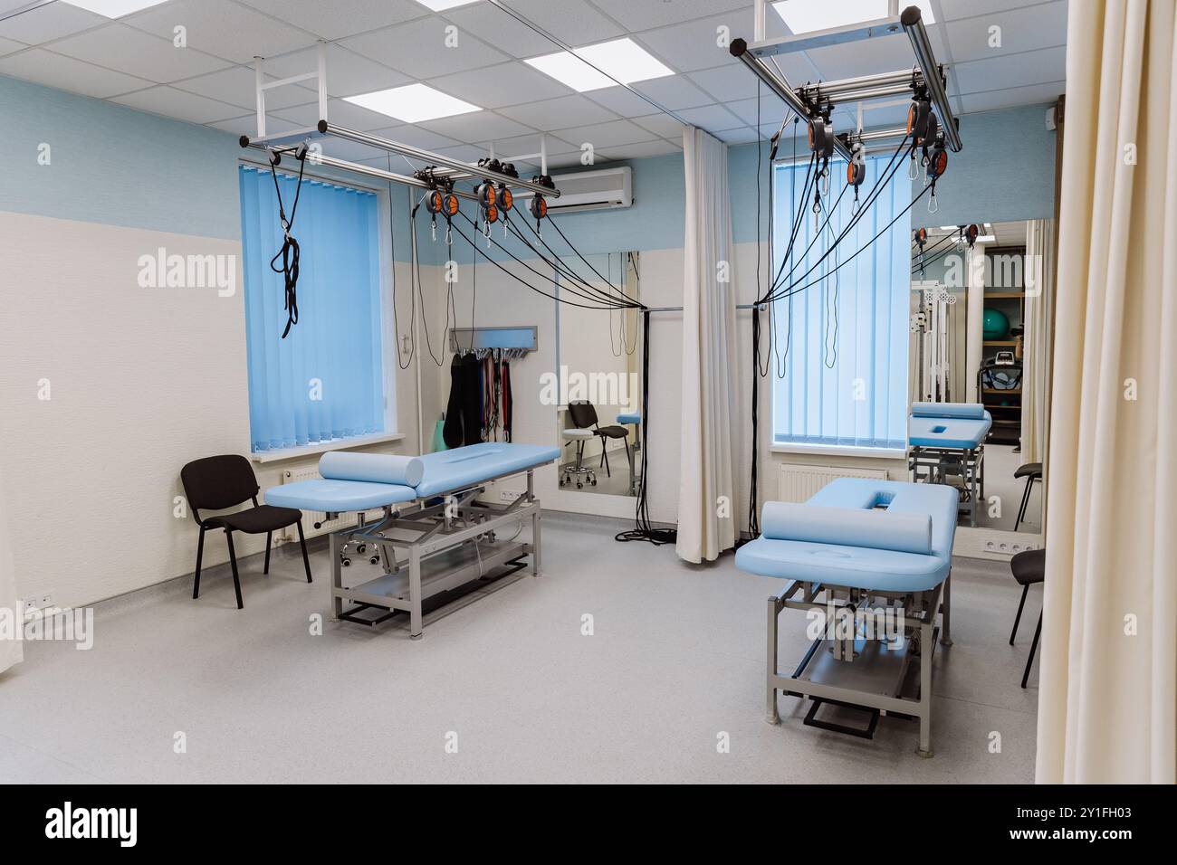 Rehabilitation room with therapy beds, suspension systems, and medical ...