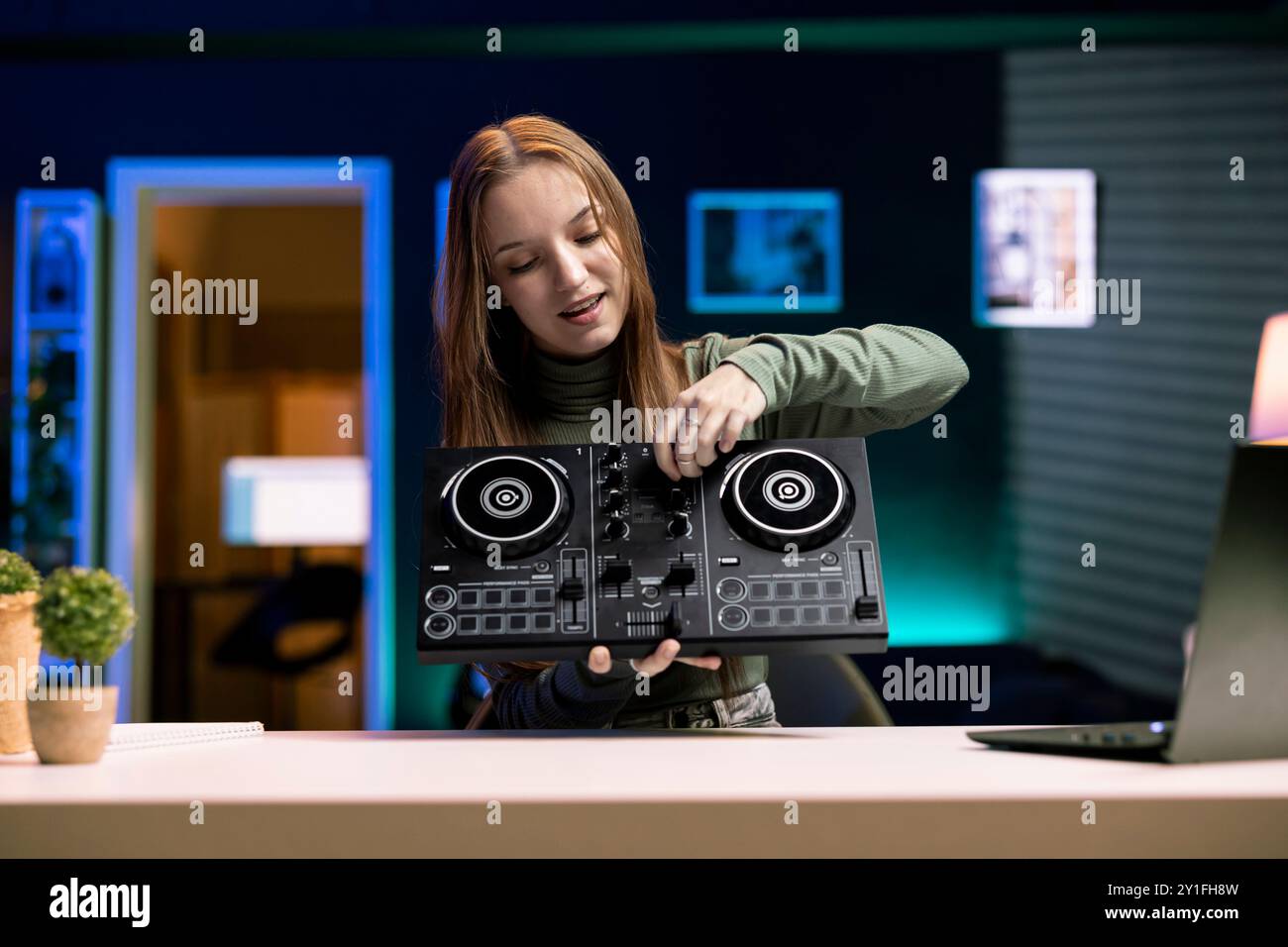 Cheerful young artist filming DJ mixing tutorial in home studio ...