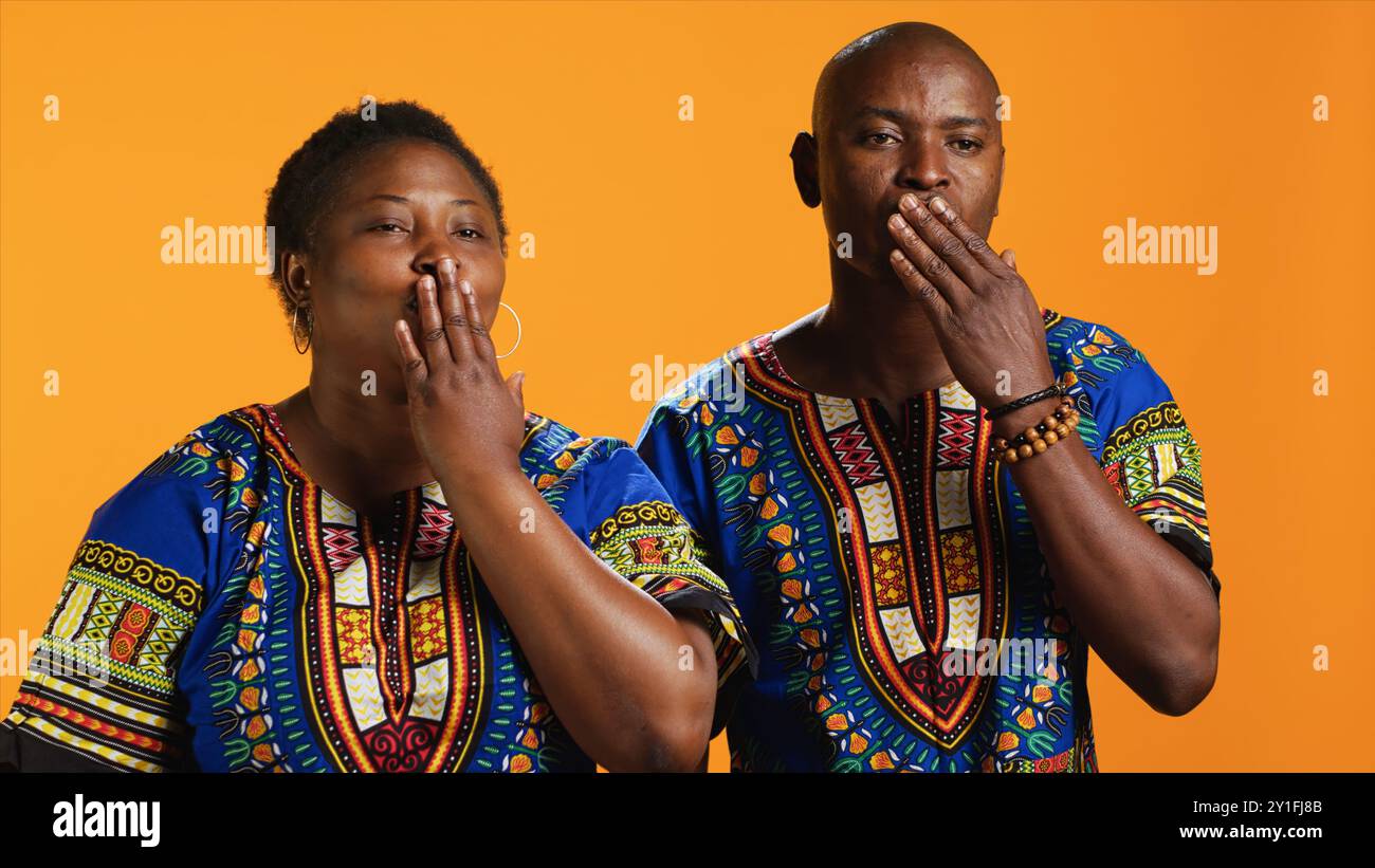 Ethnic couple blowing air kisses in front of camera, doing romantic ...