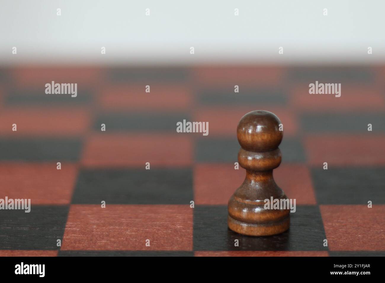 Wooden pawn chess piece on board with white background Stock Photo - Alamy