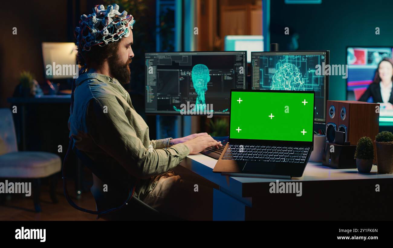 Engineer with EEG headset on programming brain transfer into computer ...