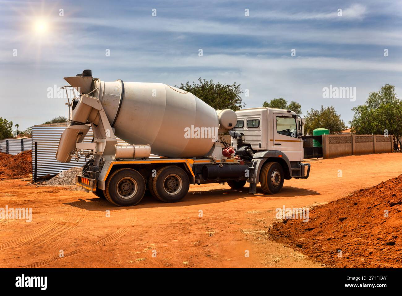 concrete mixer trucks on a dirt road on construction site Stock Photo ...