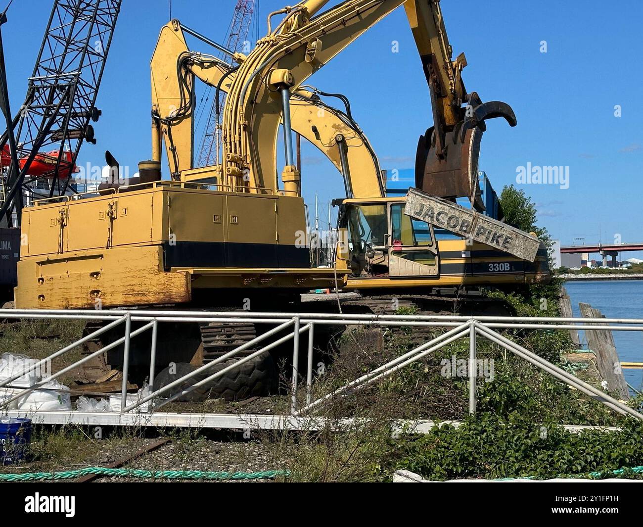 An excavator pulls the Jacob Pike ship nameplate from the debris in the ...