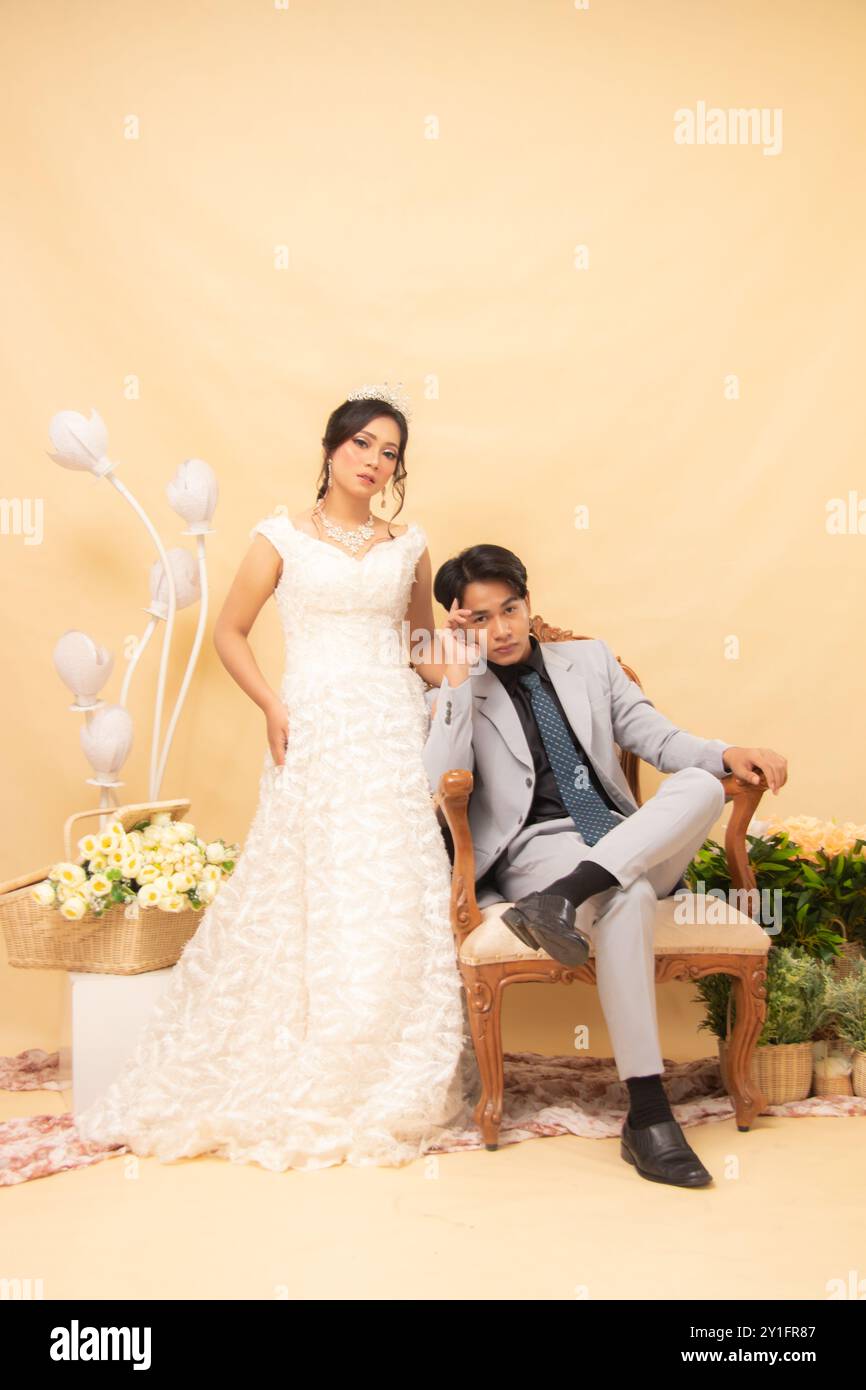 elegant male and female couple poses sitting on lounge chairs all women ...