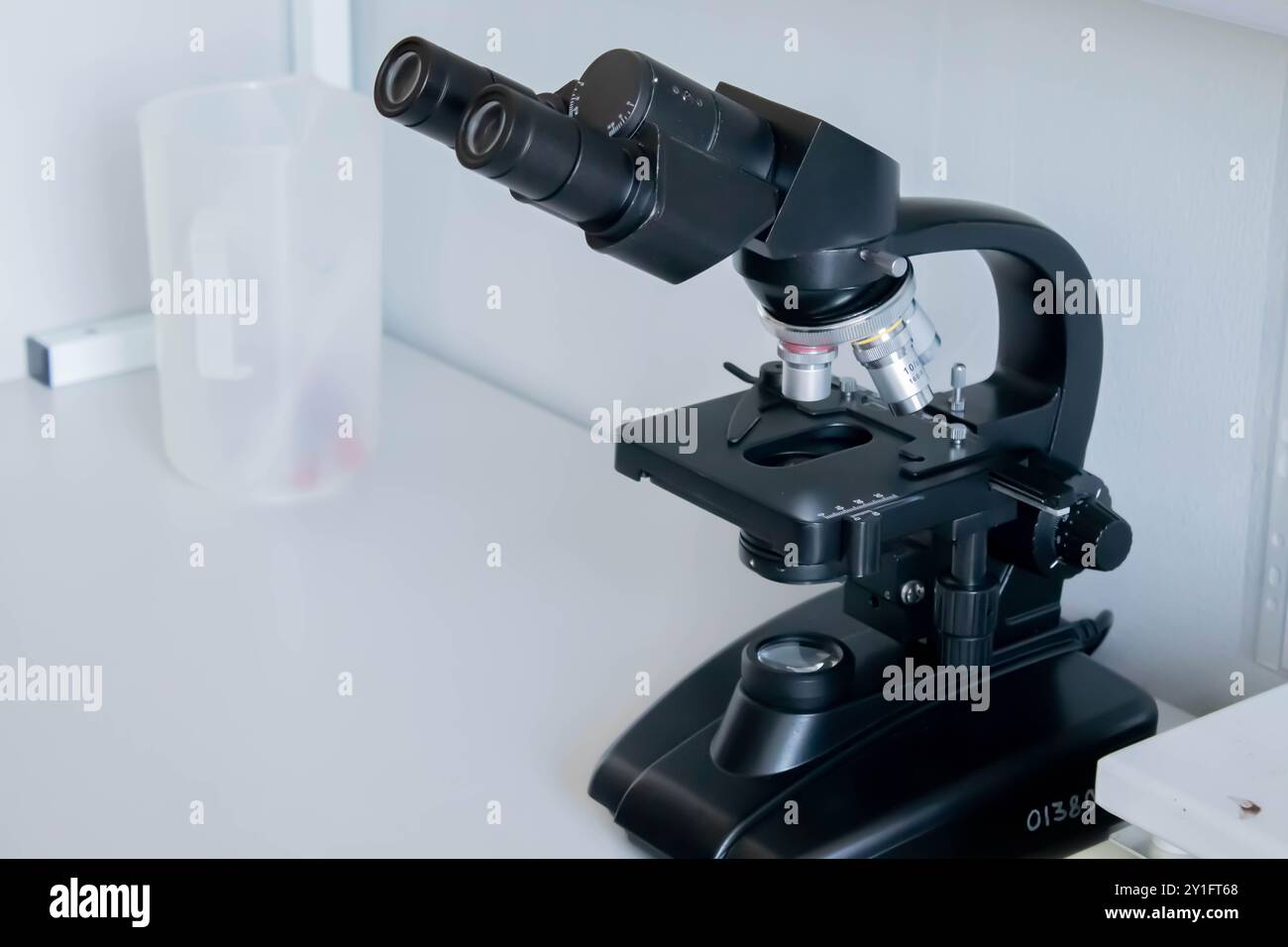 Old black microscope isolated on white background Stock Photo - Alamy