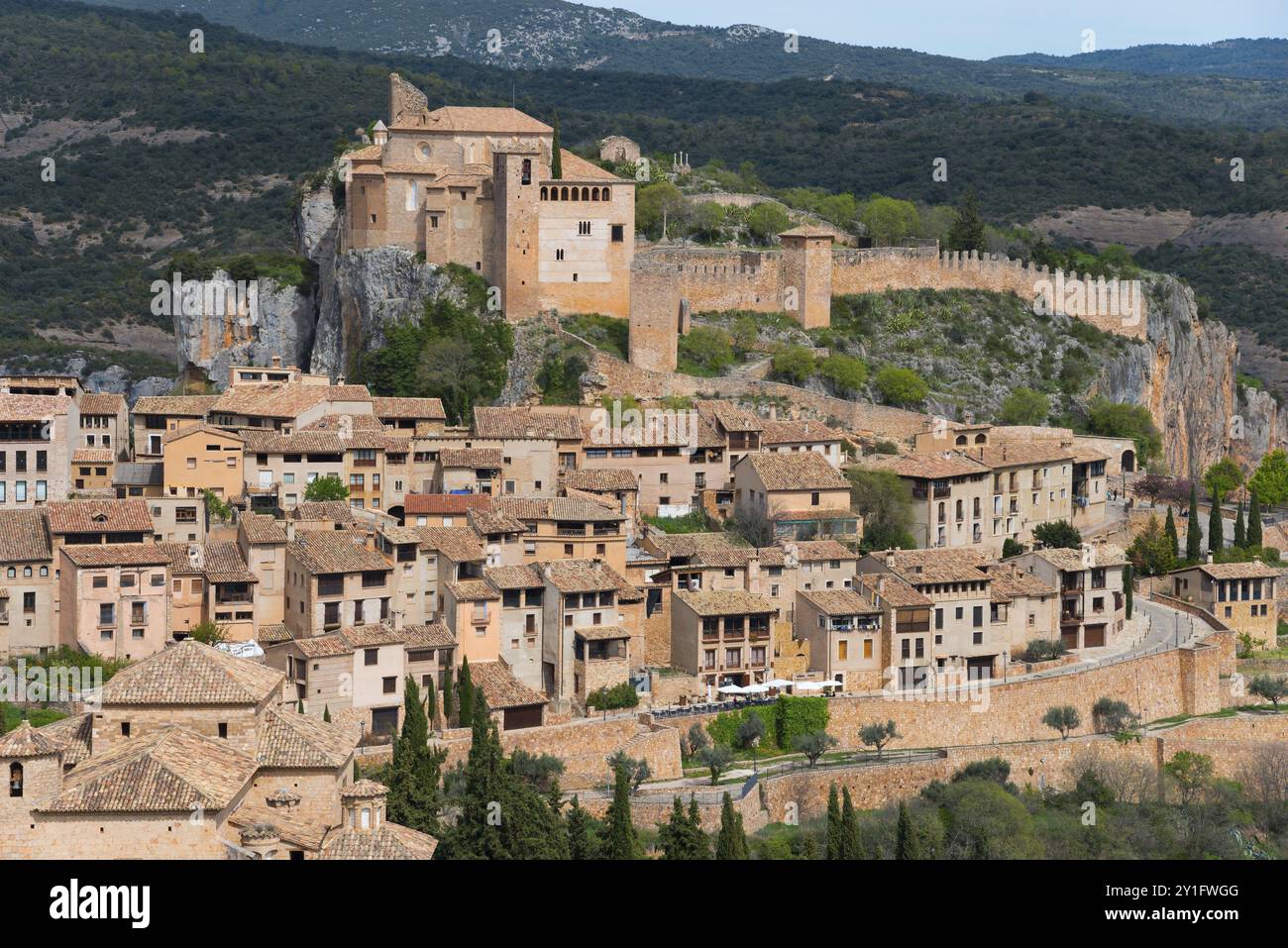 Historic castle overlooking a medieval village, surrounded by green ...