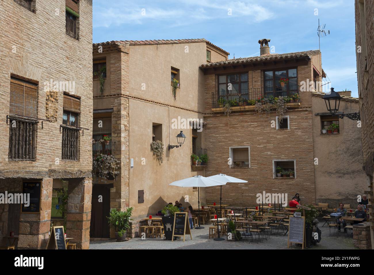 A cosy pavement cafe among historic buildings in a small, sunny town ...