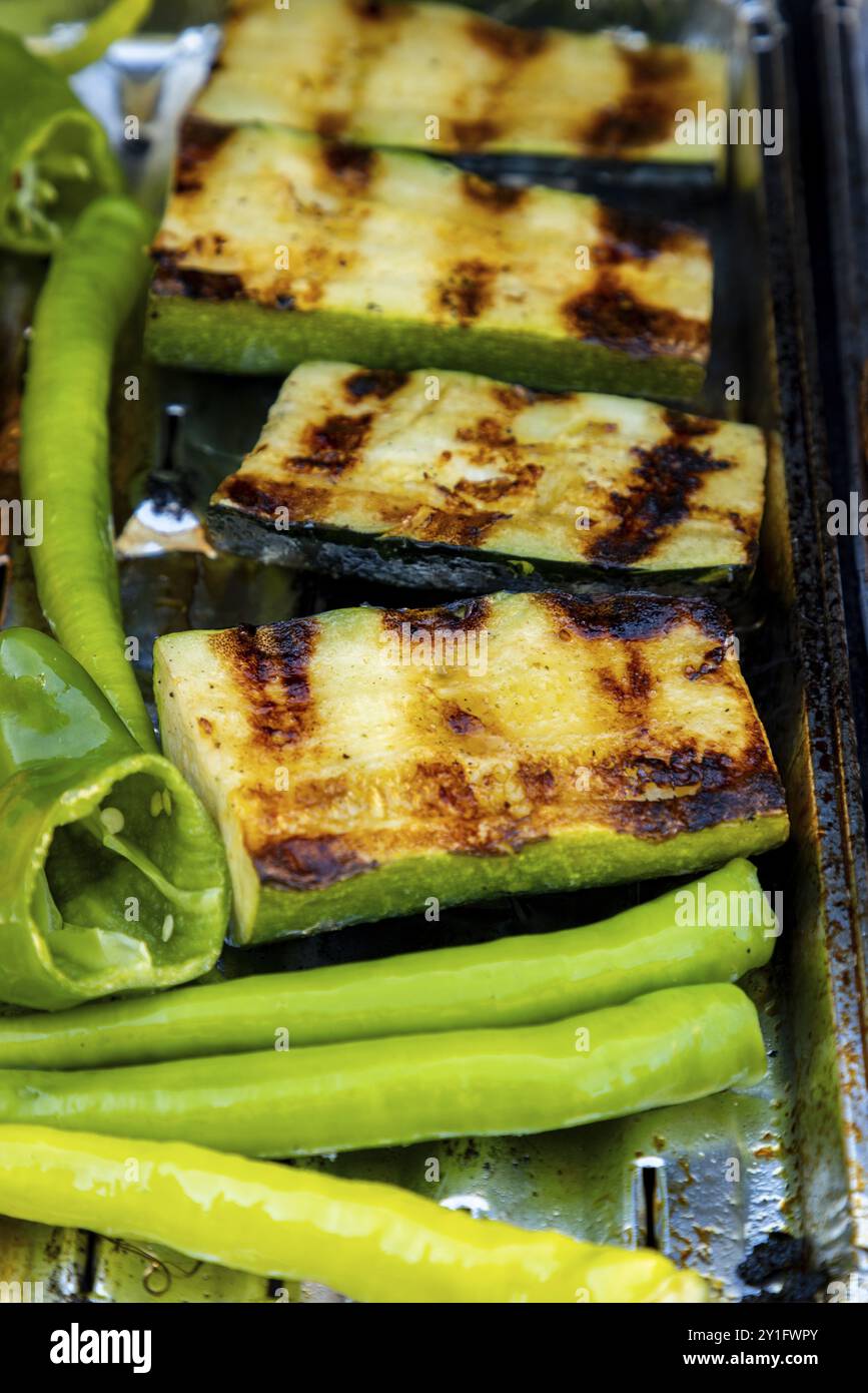 Grilled courgettes and green peppers with grill strips on a barbecue ...