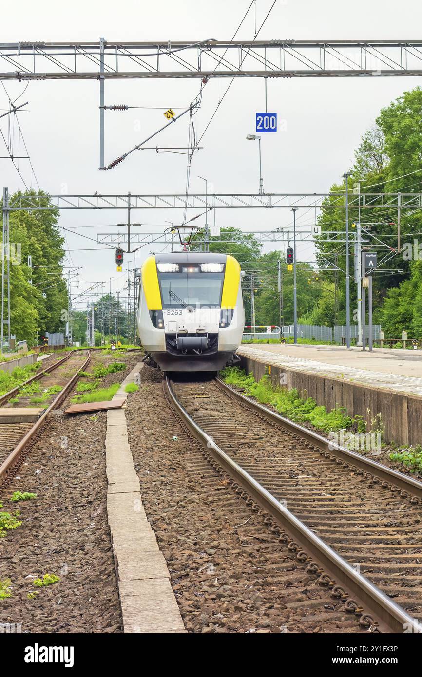 Commuter train entering a railway station, Sweden, Europe Stock Photo ...