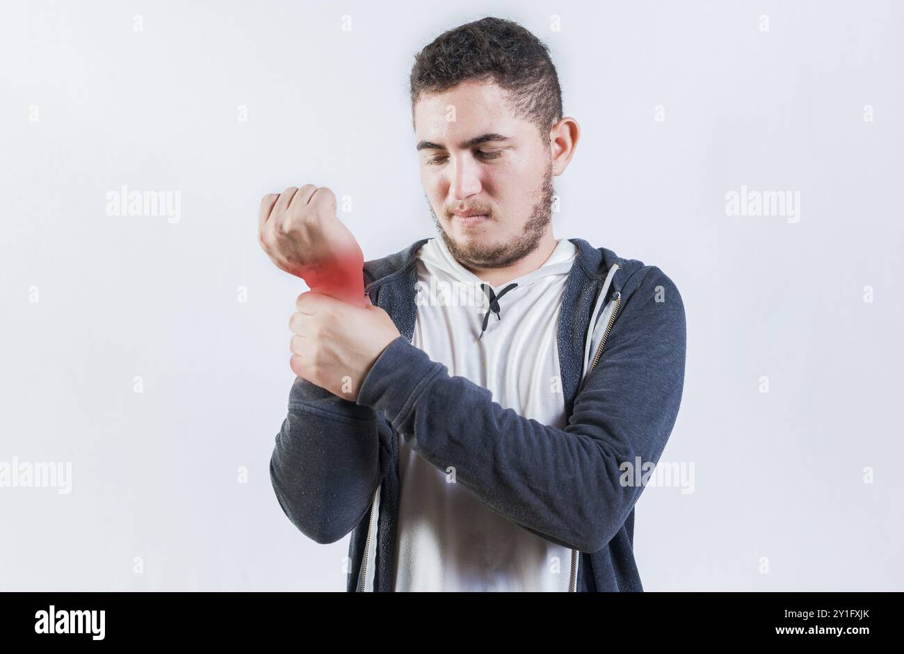 Suffering young man with pain in hand joints isolated. Person with ...