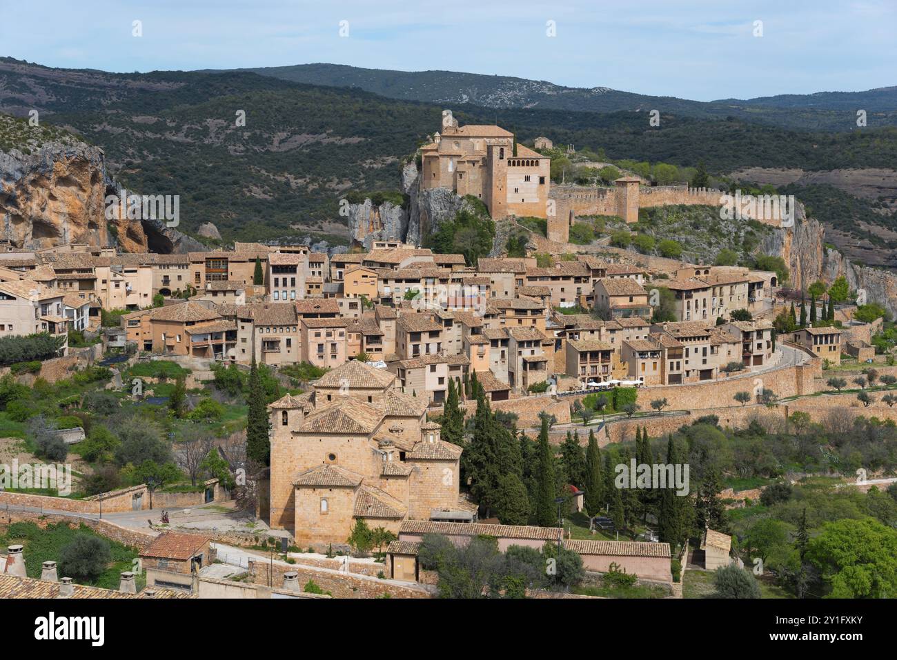 Medieval village with an impressive castle on a hill surrounded by ...