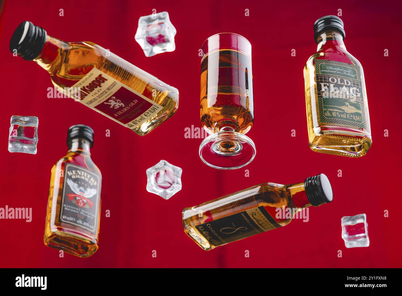 Four whisky bottles and a glass of whisky between ice cube cubes ...