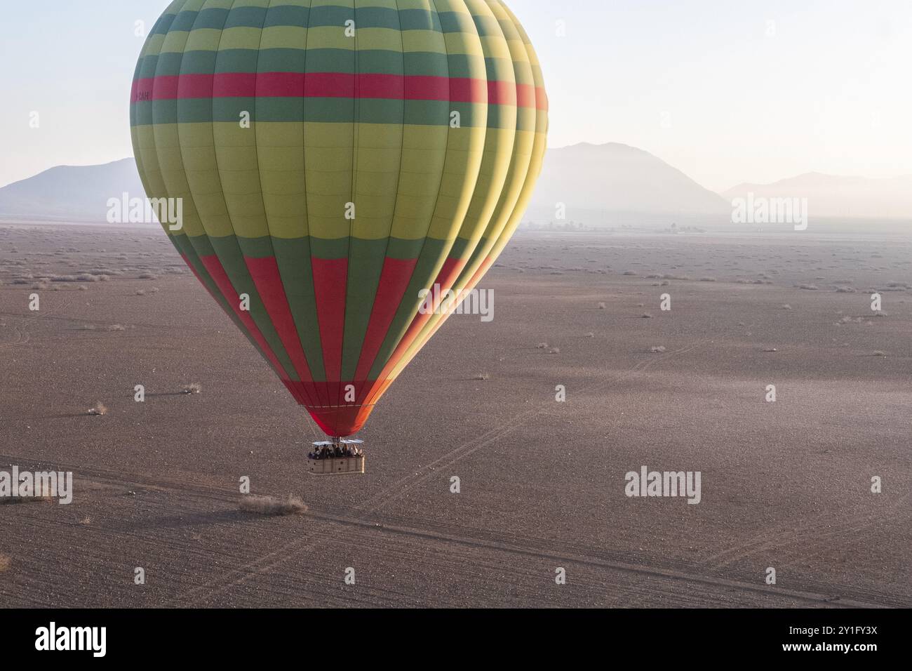 Aerial view of a hot air balloon flying over the desert near Marrakech ...