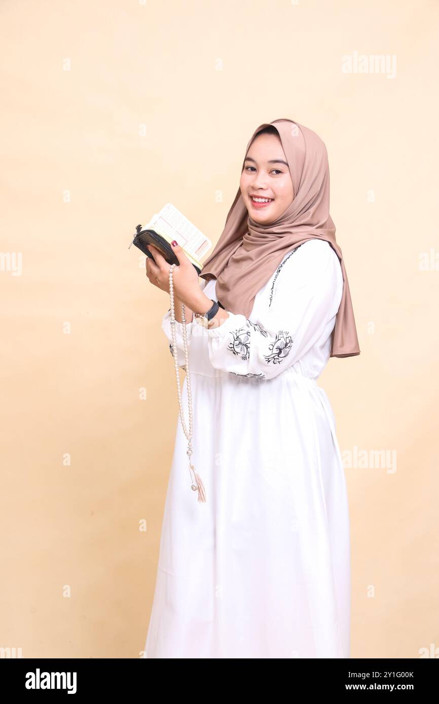 beautiful Asian Muslim adult girl in hijab to the right smiling at the ...