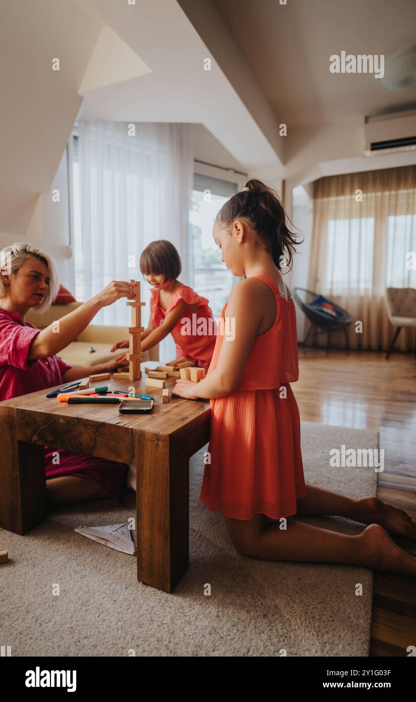 Family bonding time with playful wooden block activities at home Stock ...